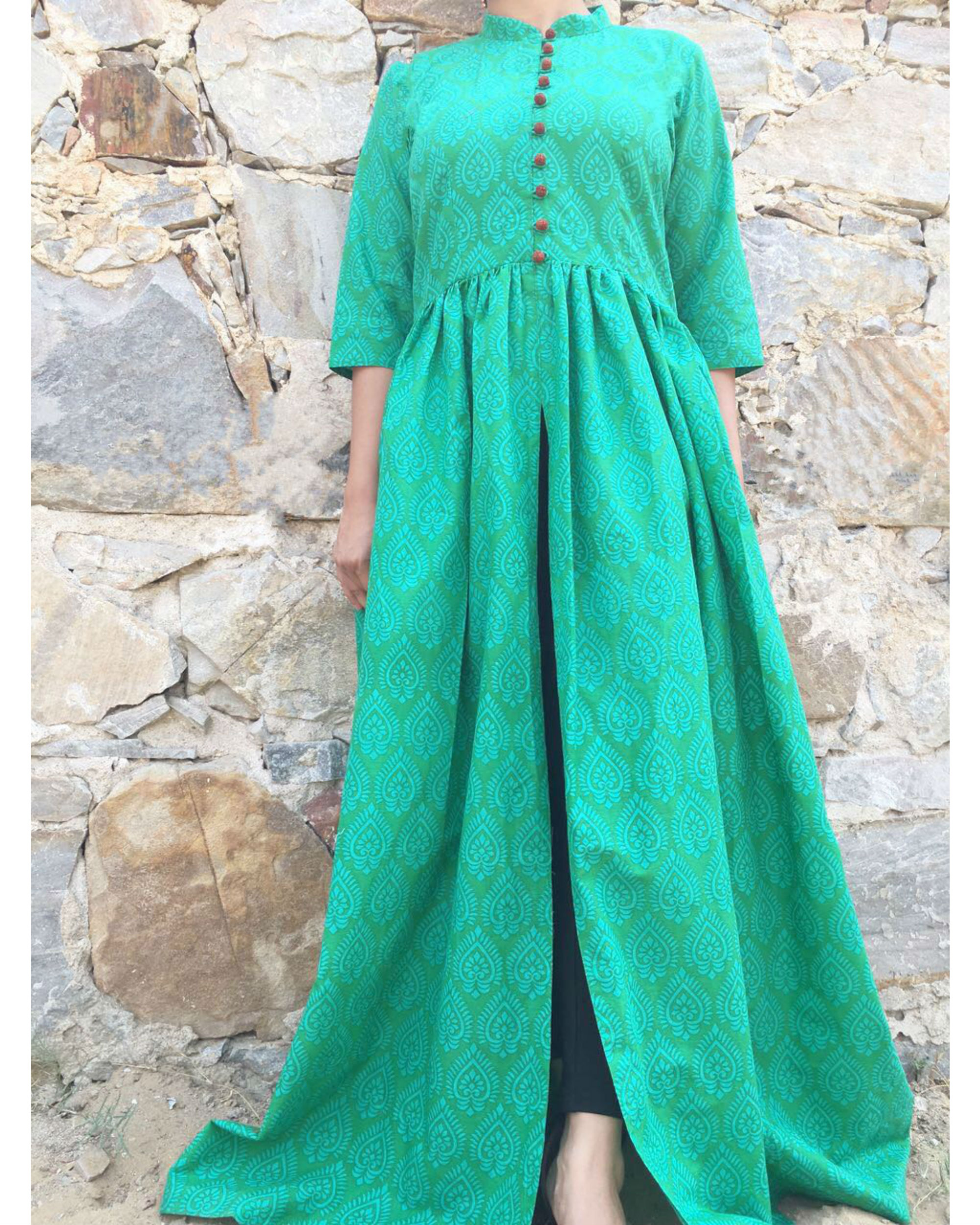 Green pleated cape by The Home Affair | The Secret Label